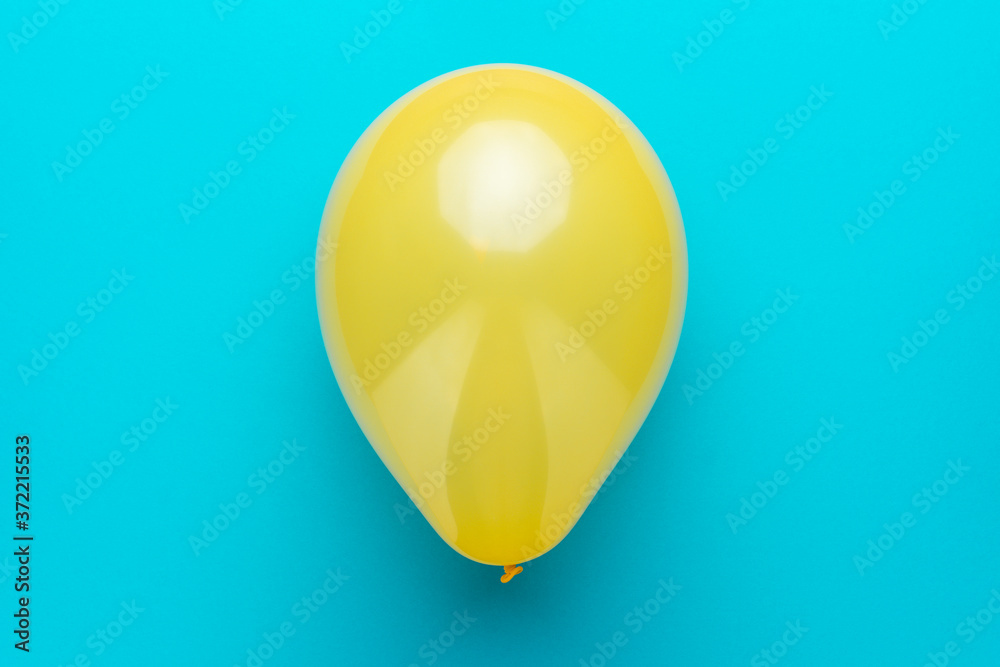 Overhead image of yellow balloon with central composition. Minimalist ...