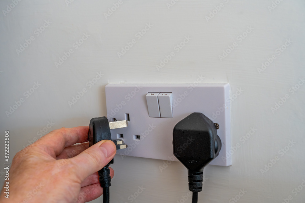 Foto de Selected Focus Plugging in a United Kingdom ( British) three ...