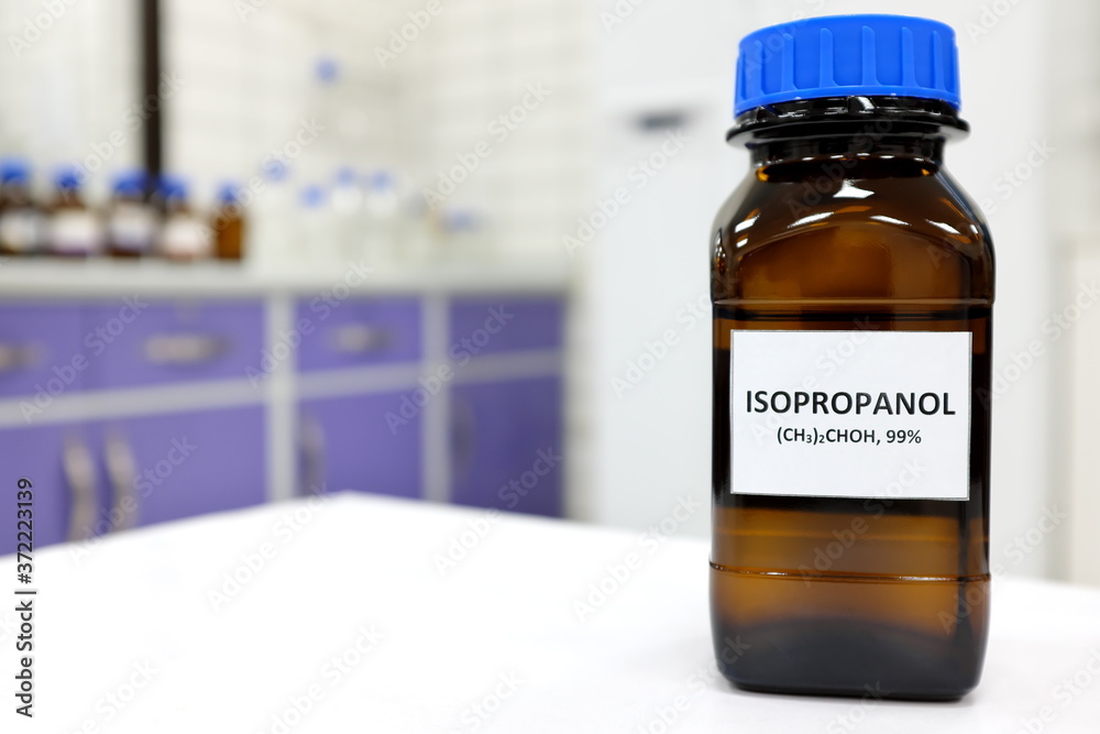 Selective focus of isopropanol brown amber glass bottle inside a ...