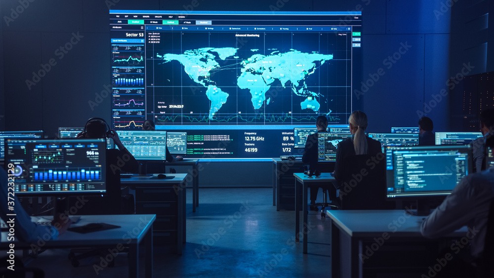 Team of Professional Computer Data Science Engineers Work on Desktops ...