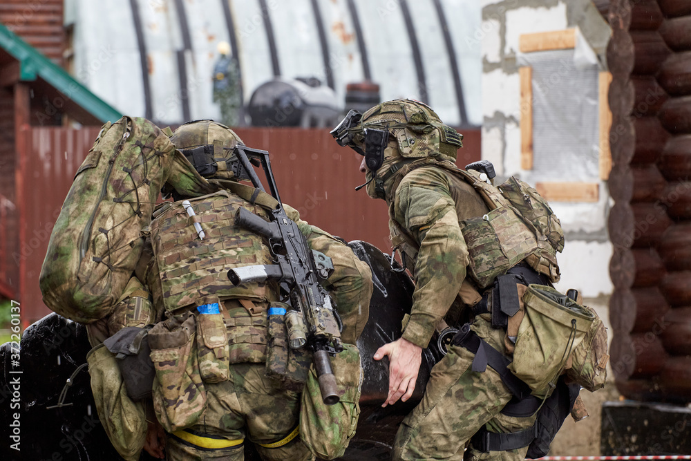 Special Forces soldiers roll a huge wheel Stock Photo | Adobe Stock