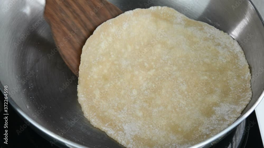 Making roti Indian bread. Cooking roti in heated pan. Stock Video ...