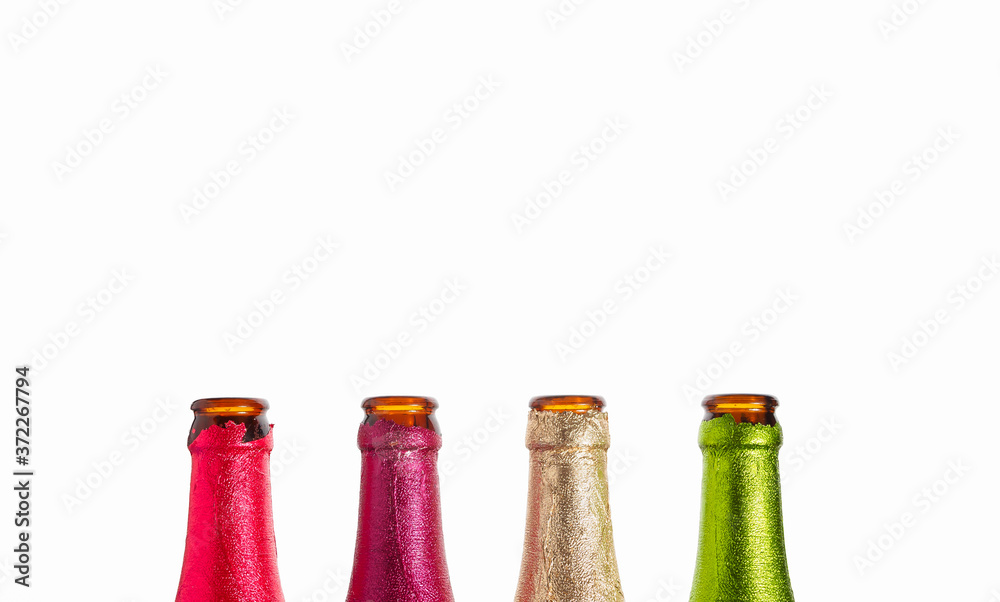 4 bottle necks are in a row, colored foil on the necks white background foto de Stock | Adobe Stock