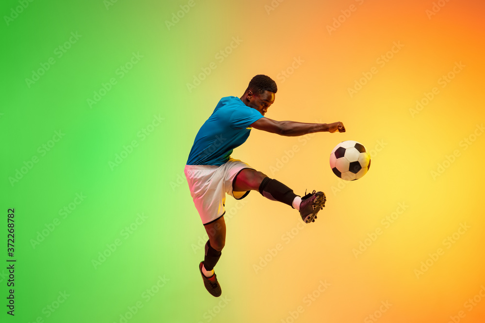 High jumping. Male soccer, football player training in action isolated ...