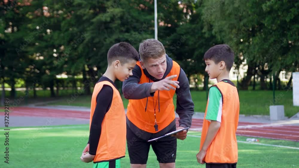 Vidéo Stock Front view of confident experienced young football coach ...