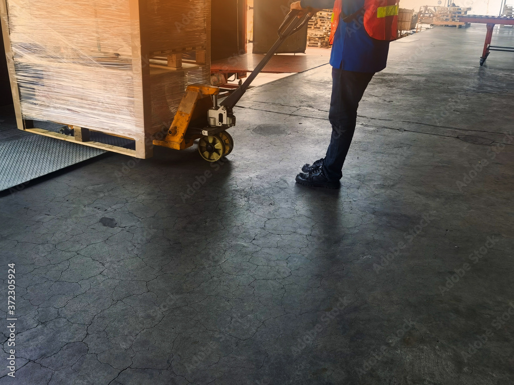 Worker driving forklift loading shipment carton boxes and goods on ...
