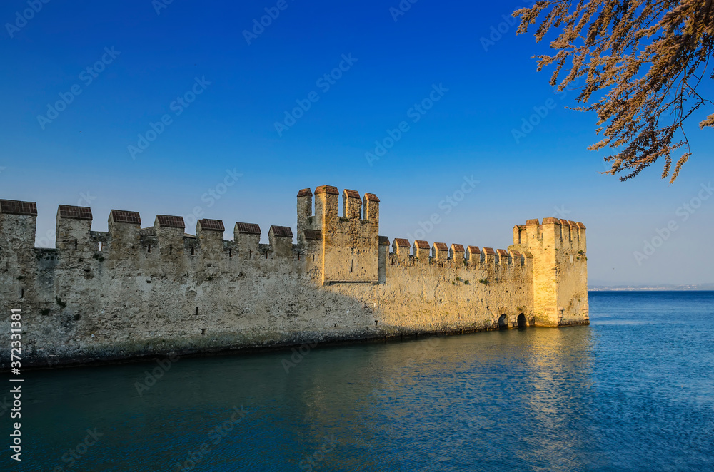 Rocca Scaligera. Unique 13th-century castle surrounded by water, with ...