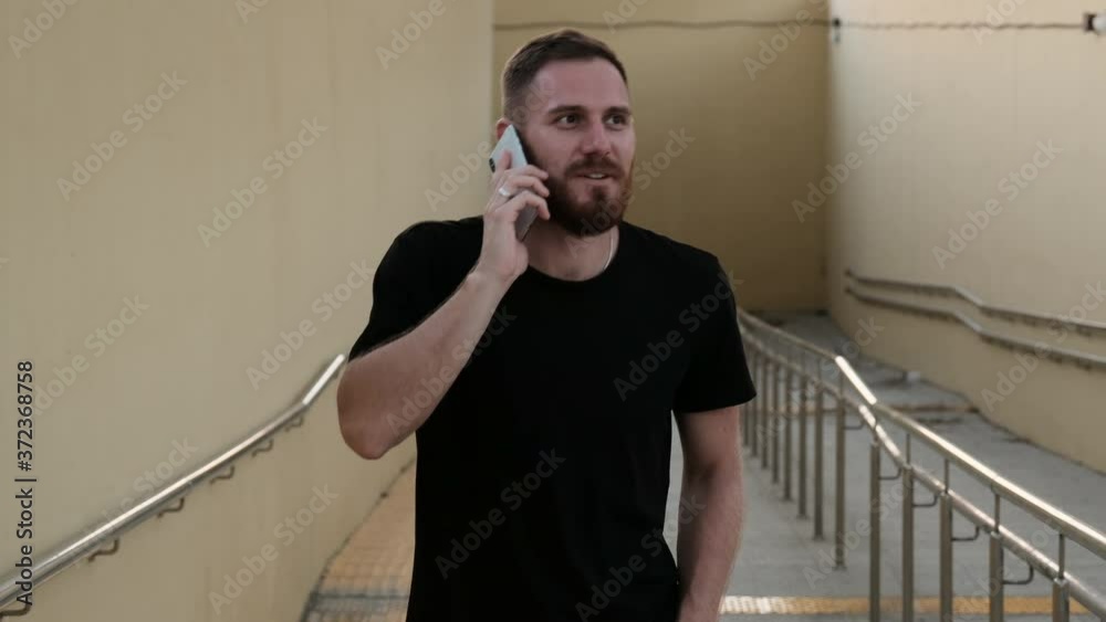 Bearded guy with red hair in black T-shirt of caucasian appearance is ...