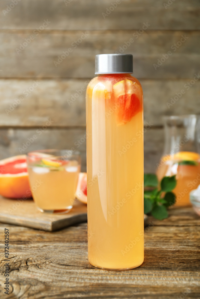 Bottle of fresh grapefruit juice on table Stock Photo | Adobe Stock