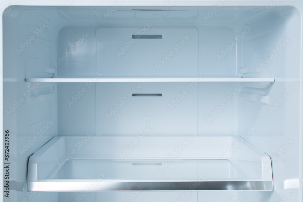 Clean empty shelves in white refrigerator. Empty open fridge with ...