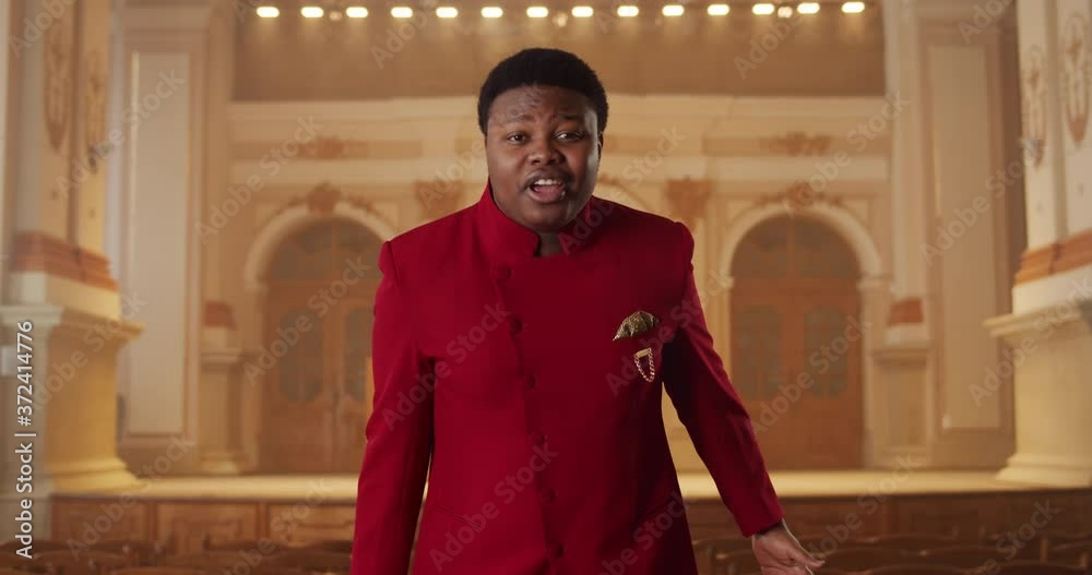 Front view of young african american man singing gospel music. Male ...