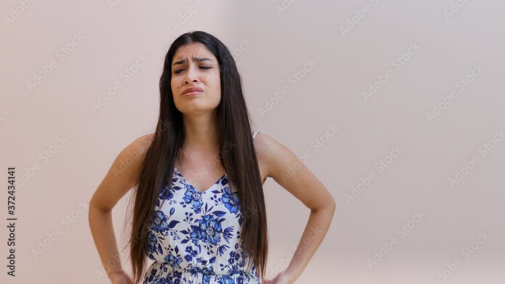 Video Stock Young girl showing negative emotions while standing against ...