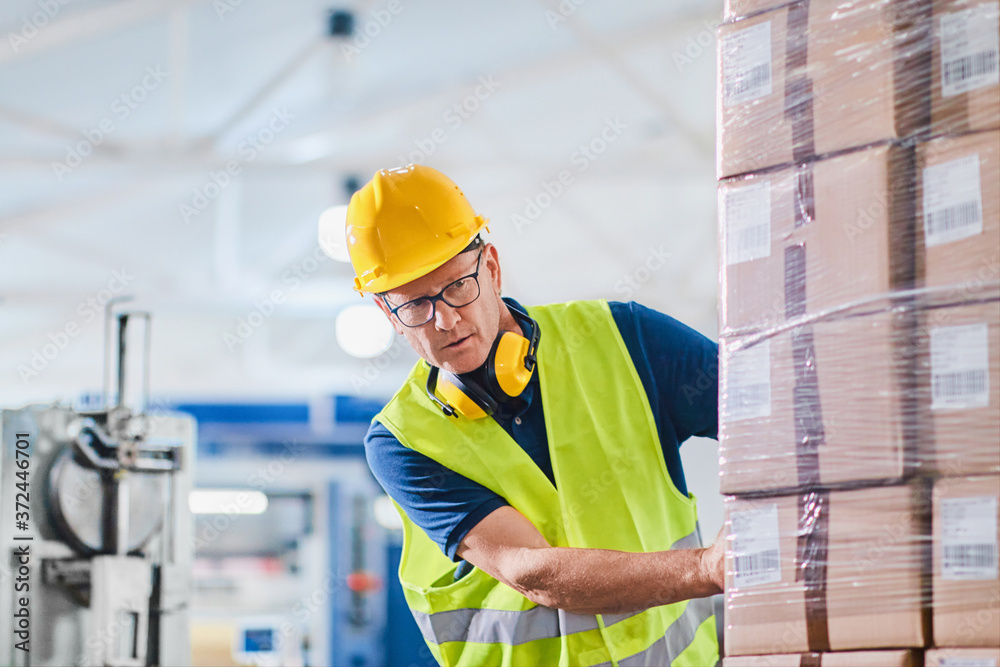 Warehouse worker using forklift and sorting boxes Stock Photo | Adobe Stock