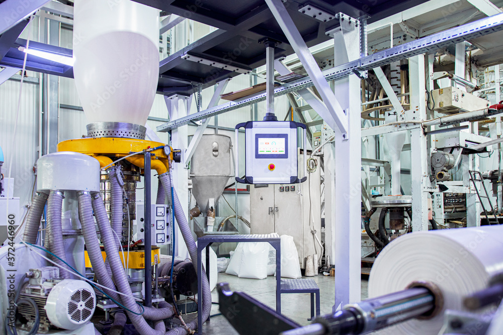 Modern automated production line in factory. Plastic bag manufacturing ...