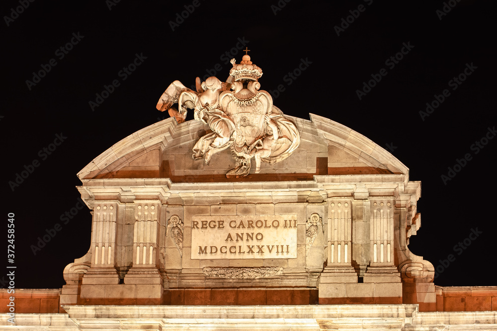 Night detail of the Puerta de Alcalá, royal coat of arms crowning the ...