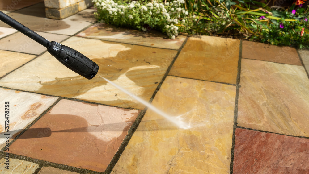 Detail of Jet or Pressure washing natural stone garden paving slabs ...