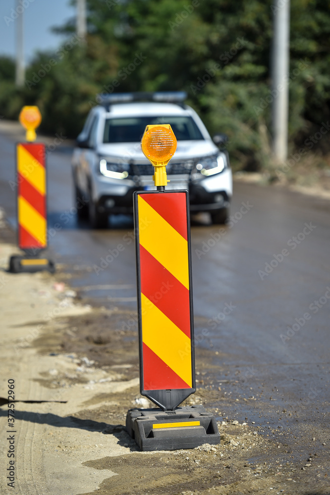 Yellow warning lights in a hazard zone during construction road works ...