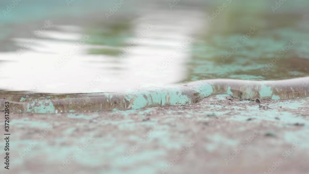 Macro shot of sheet of water running slowly, Laplace's law, example of ...