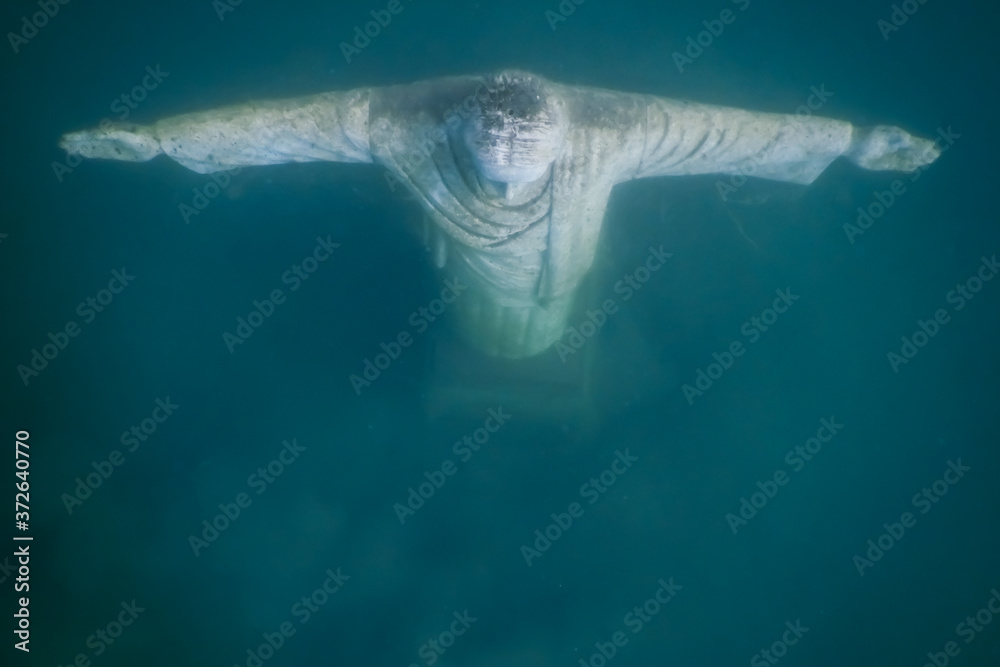 jesus statue from above while diving in a lake Stock Photo | Adobe Stock