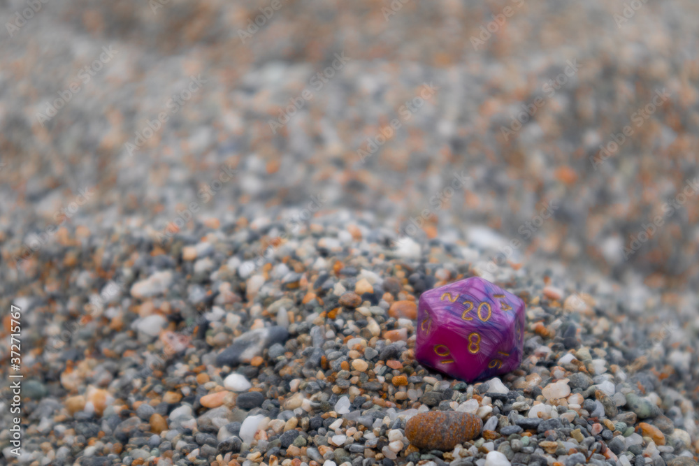 Purple Pink Dungeon and Dragons dice with character sheets at the beach ...