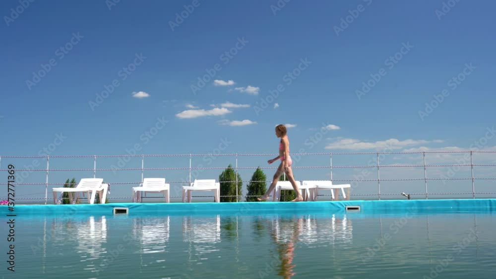 teenage girl in swimsuit goes along pool background sky Stock Video ...
