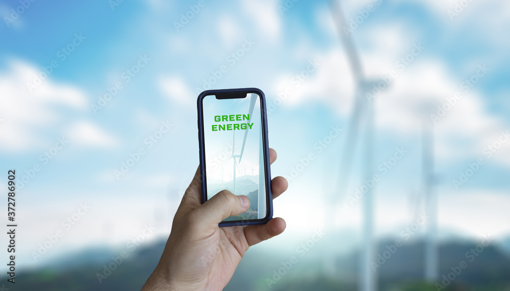 Alternative energy, man photographs wind farms, green energy principle ...