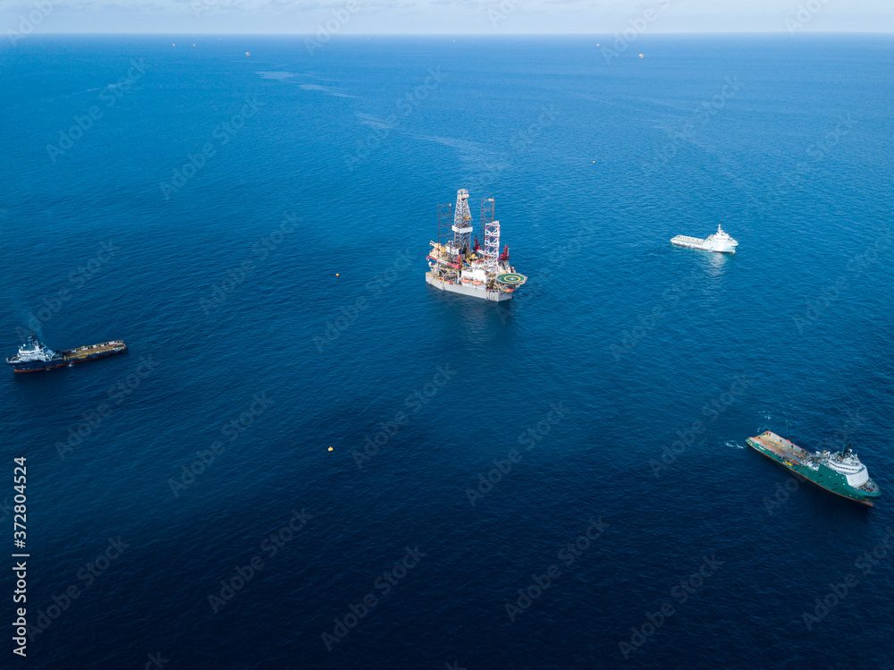 Offshore jack up rig and tow vessels during the rig move operation at ...