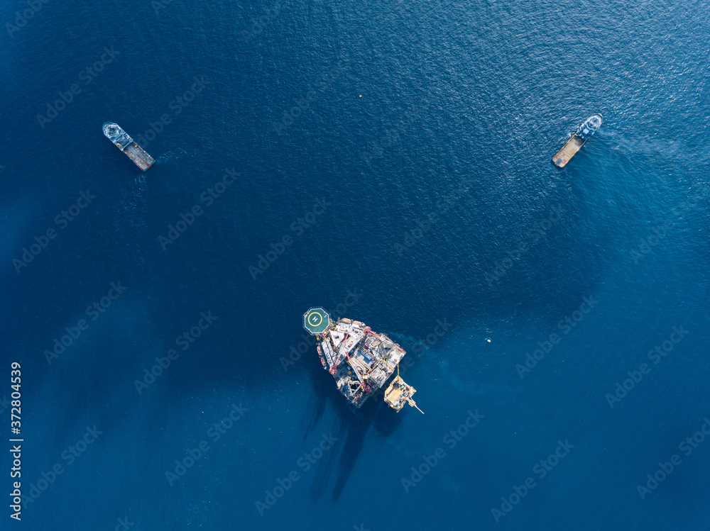 Offshore jack up rig and tow vessels during the rig move operation at ...