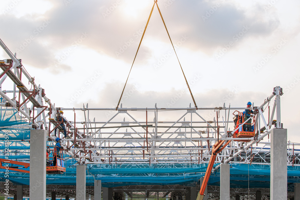 Steel structure roof truss frame installation by mobile crane under the ...