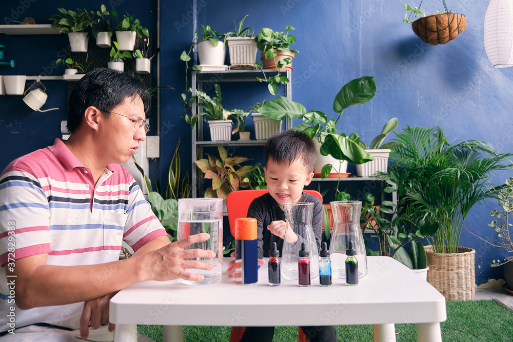 Parent sitting homeschooling with little kid, Father and son having fun ...