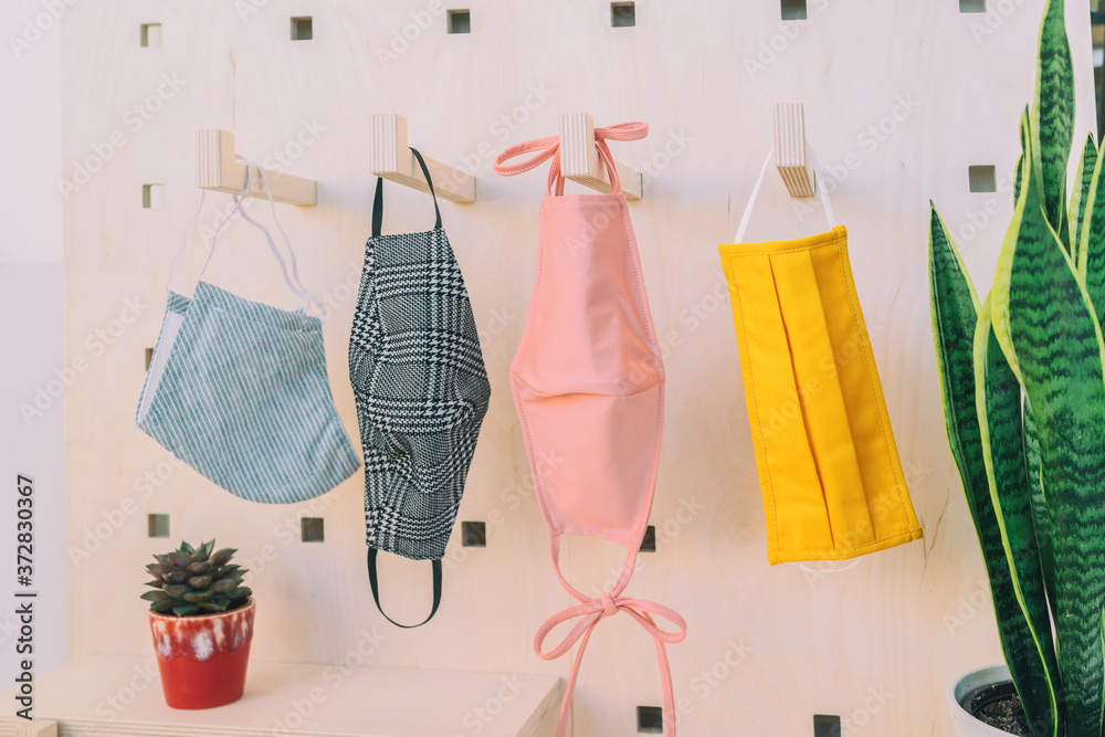 Masks of many colors for corona virus prevention hanging on wall at ...