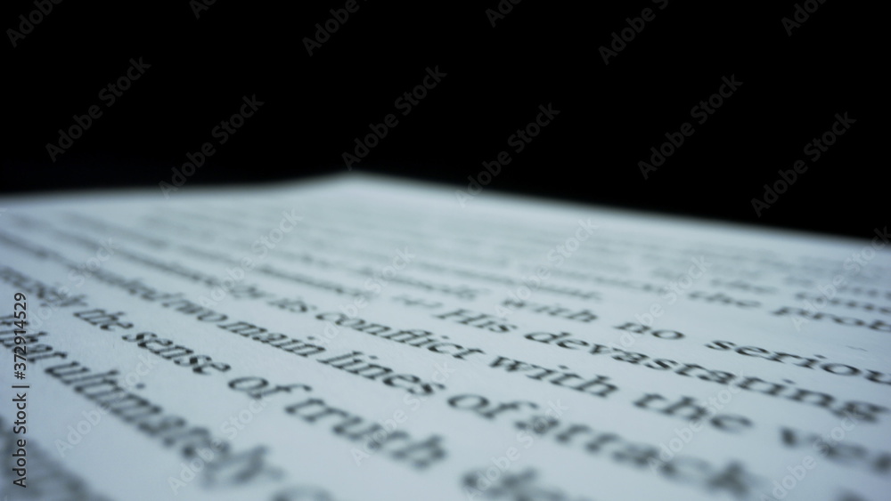 Detailed view open book lying on table. White book sheets with english ...
