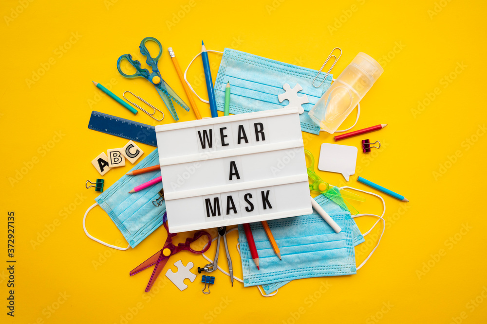 Wear a mask lightbox message with school equipment and covid masks ...
