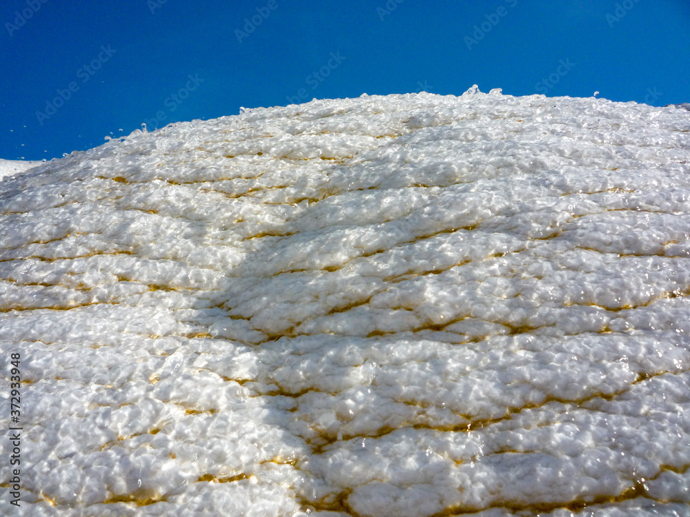 white salt Chrystal deposits in geometrical patterns with ripples and ...
