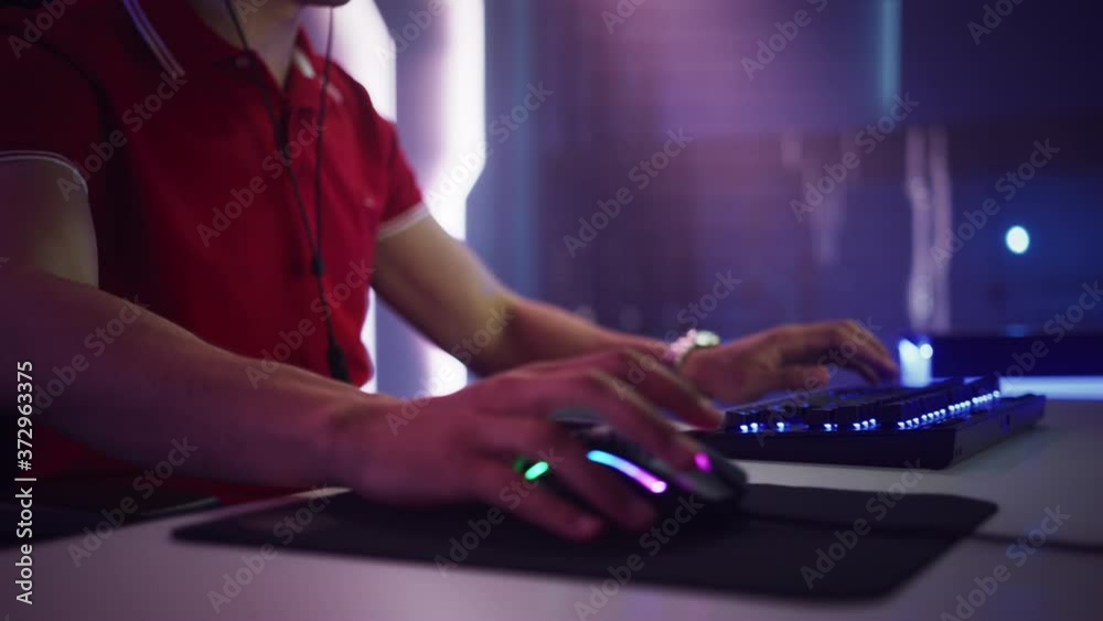 Professional eSports Gamer Sitting at Gaming Station, puts on ...