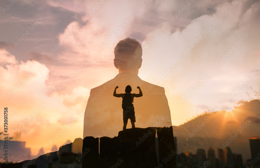 Strong man standing facing city sunrise feeling full strength and power ...