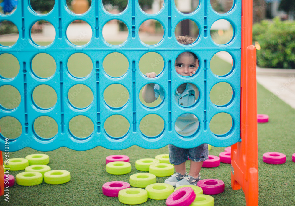 Little boy is playing the grass with a giant board game Stock Photo ...