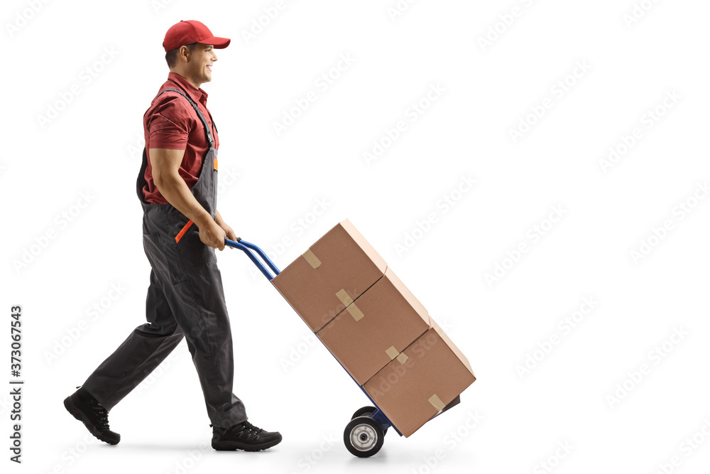 Male worker pushing boxes on a hand-truck Stock Photo | Adobe Stock