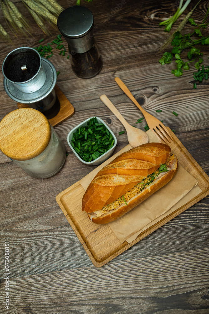 Snack at break time. Famous Vietnamese food is Banh mi thit and black ...