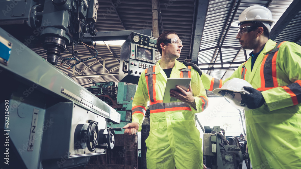 Factory worker warn coworker about safety and give hardhat to him ...
