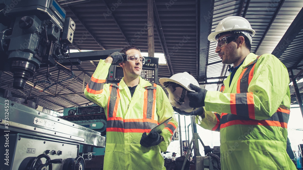 Factory worker warn coworker about safety and give hardhat to him ...