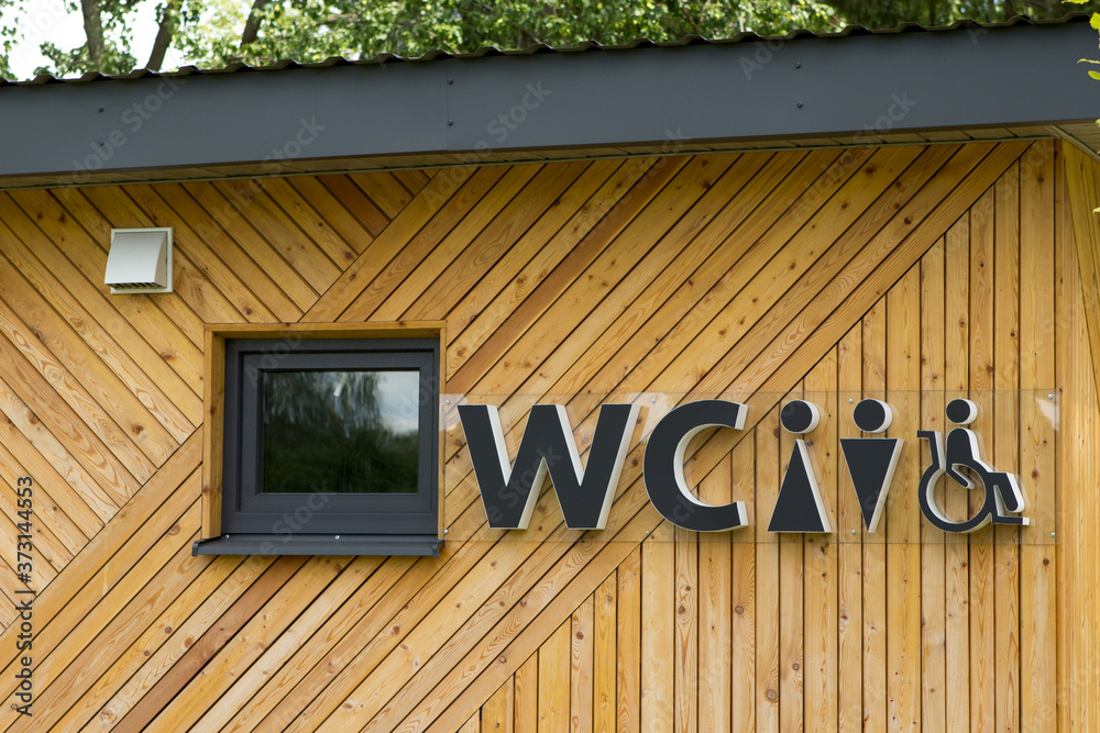 Public beautiful modern wooden toilet WC in a city park. Toilet for the ...