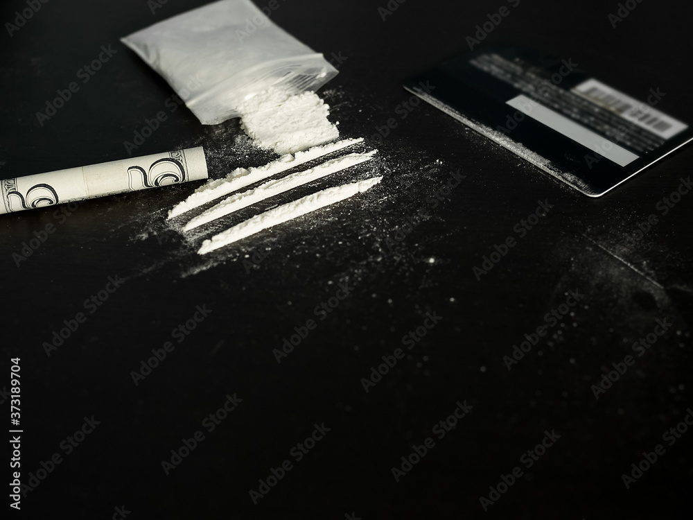 cocaine divided with blur image of banknote round roll, credit card ...