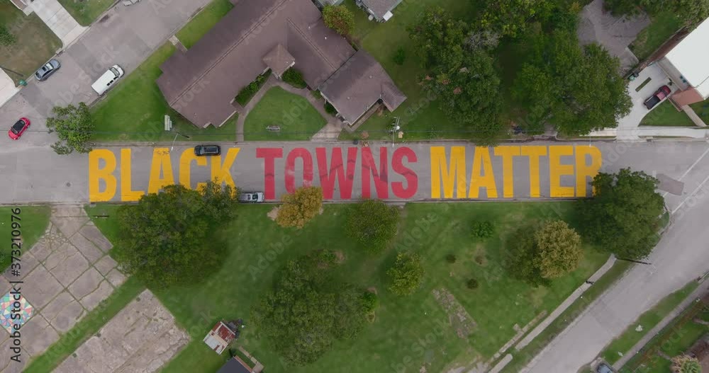 Bird eye view of a large "Black Towns Matter" sign painted on street in ...