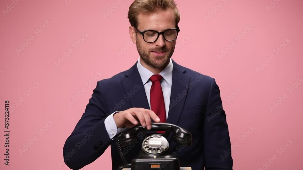 elegant businessman in navy blue suit answering old rotary phone ...