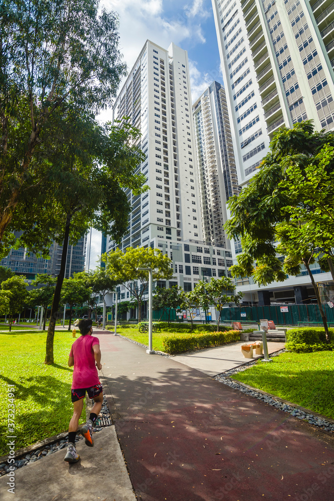 Bonifacio Global City, Taguig, Metro Manila - A man jogs at a park in ...