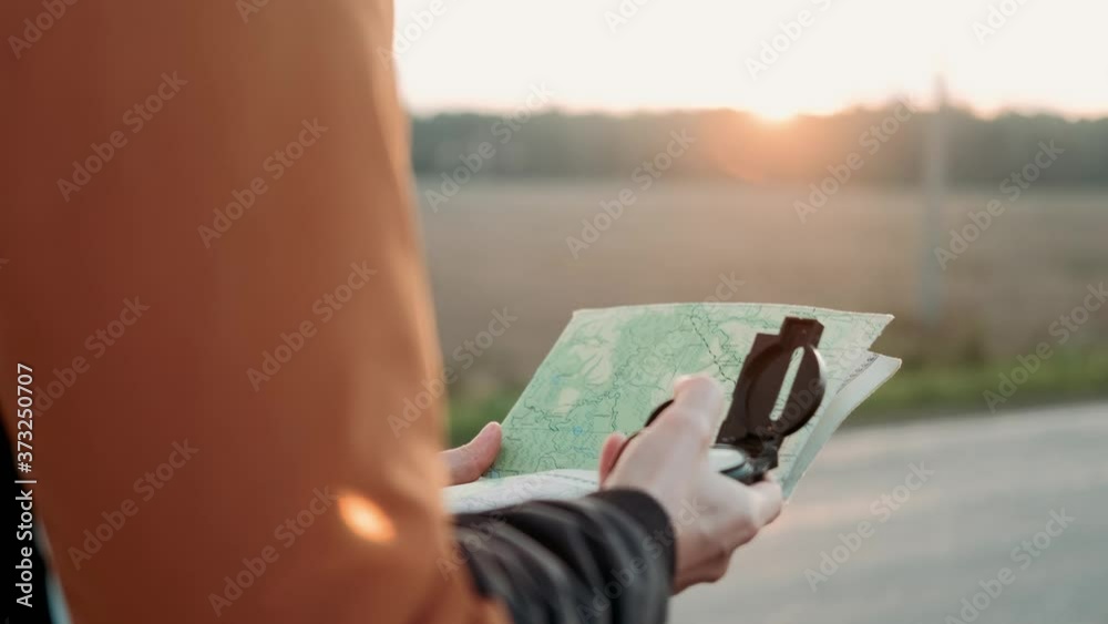 Hiking Man Using Navigation Map and Compass. Man explorer searching ...