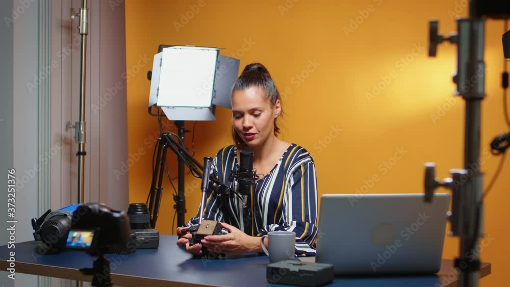 Content creator reviewing fluid head to the camera in her professional ...