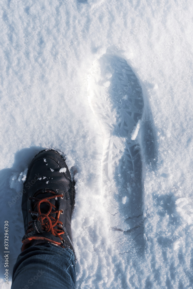 Abstract background with traces of a human foot on the snow of feet in ...