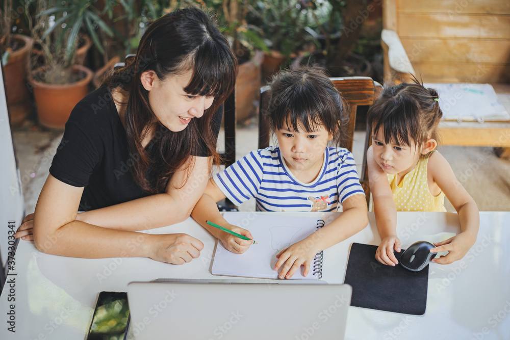 Happy family of mom and preschool daughter using laptop for remote ...